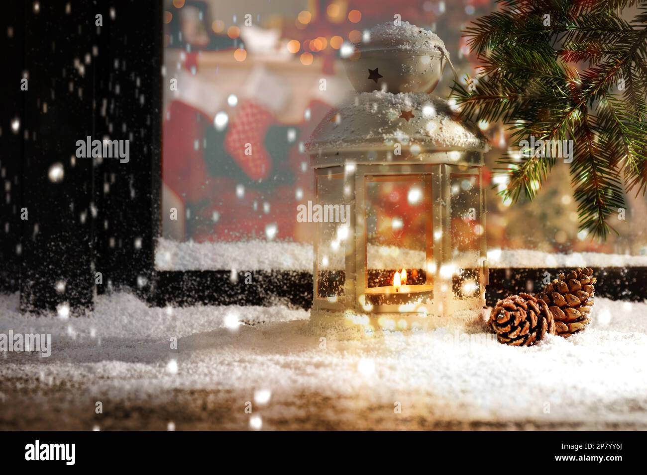 Snow falling onto window sill with Christmas lantern outdoors Stock ...