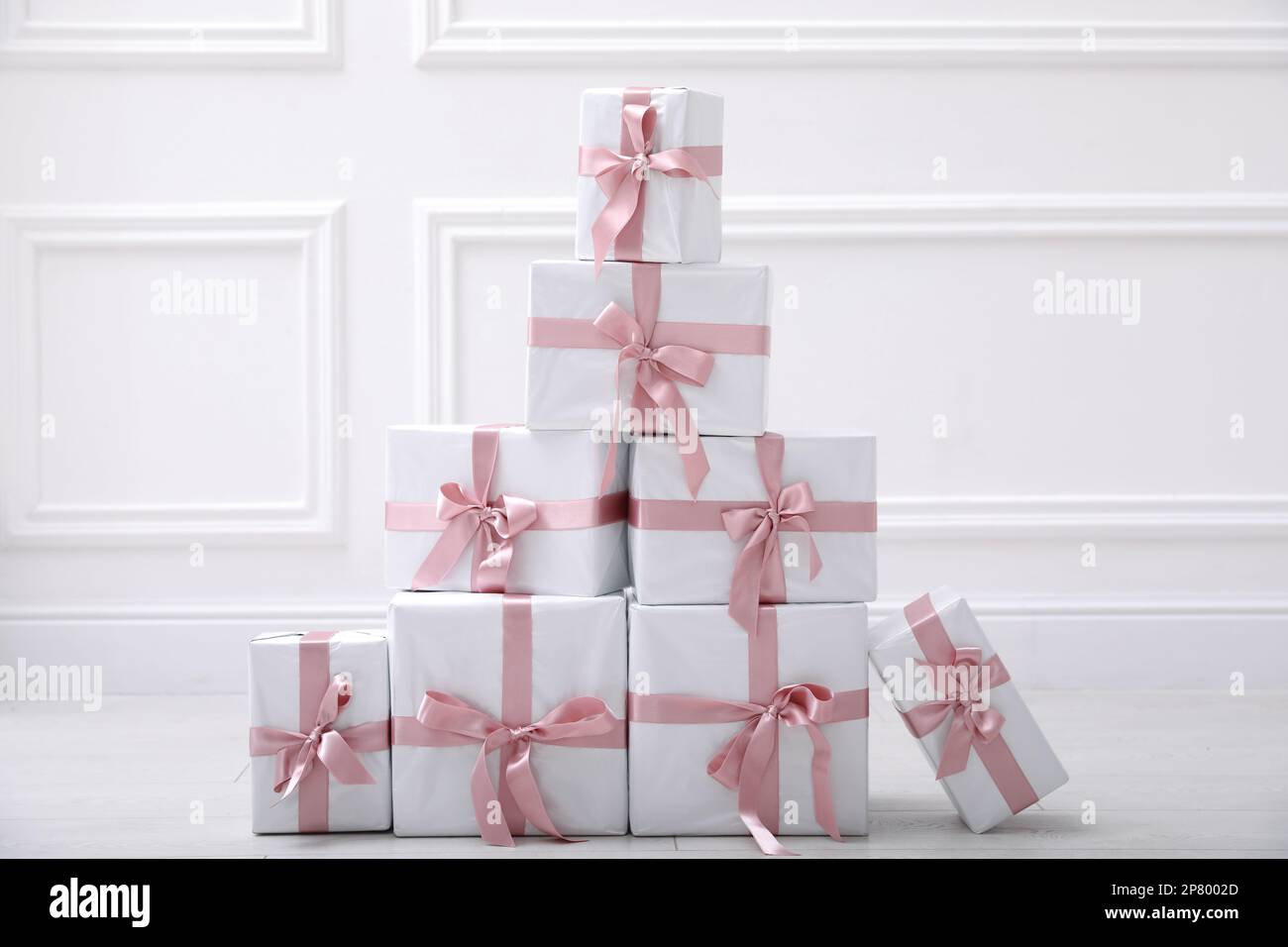 Many gift boxes on floor near white wall in room Stock Photo - Alamy