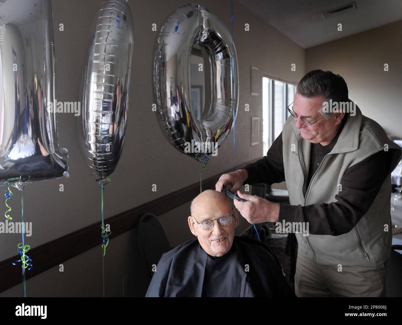 Gary Lueneburg, right, gives Francis Worden a complimentary birthday ...