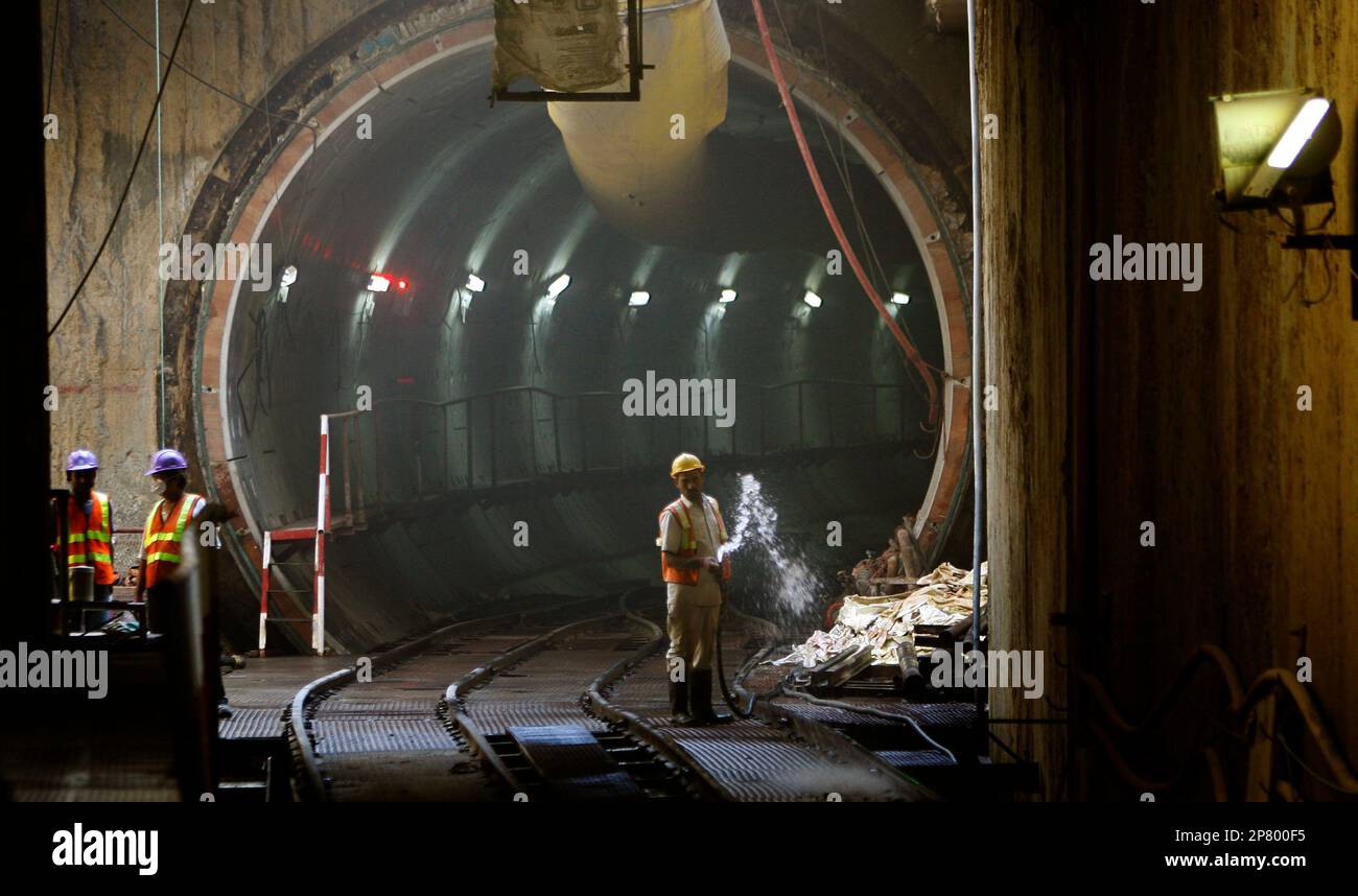 A worker cleans a Delhi Metro tunnel, in New Delhi, India, Monday, Oct ...