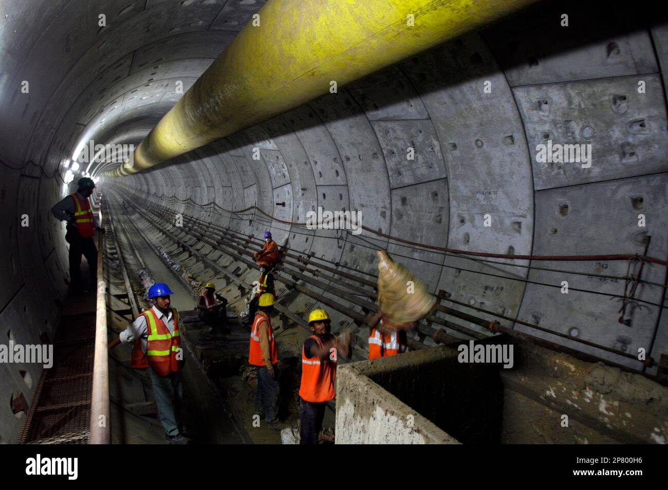 Workers take out debris from a Delhi Metro tunnel in New Delhi, India ...