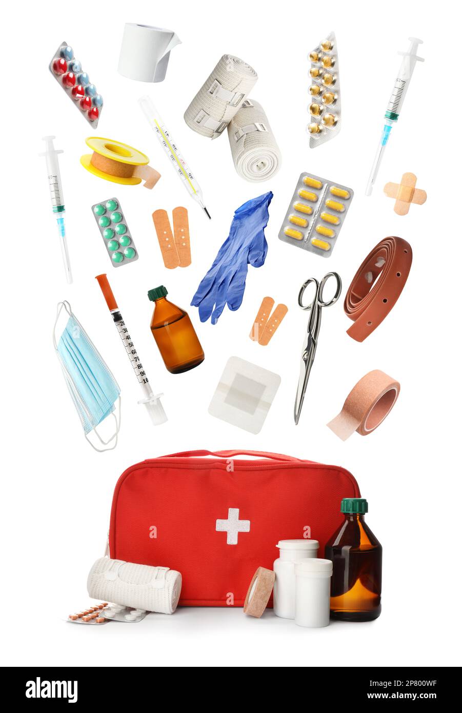 First aid kit. Different medical supplies falling on white background ...