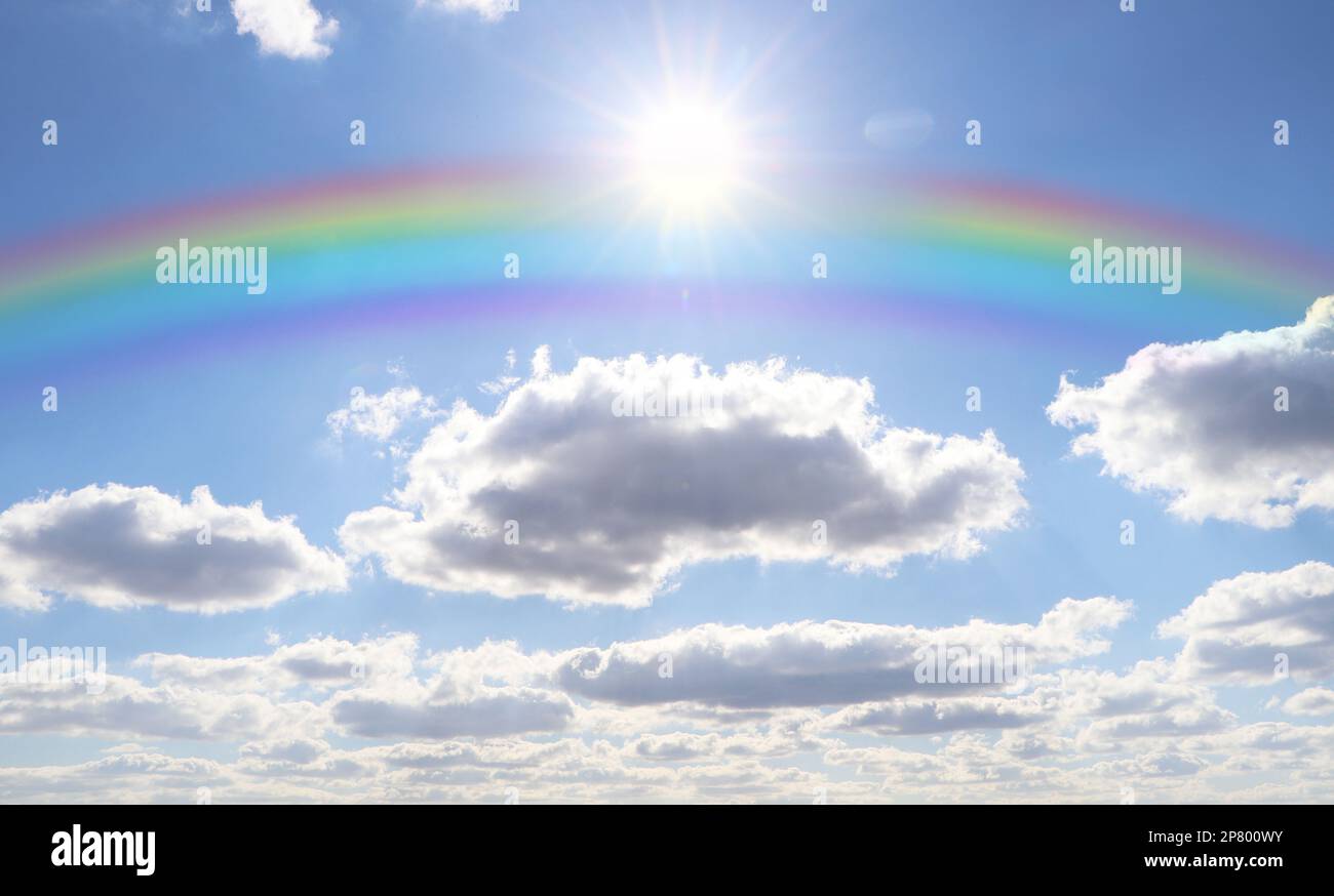 Beautiful rainbow in blue sky with white clouds on sunny day Stock ...
