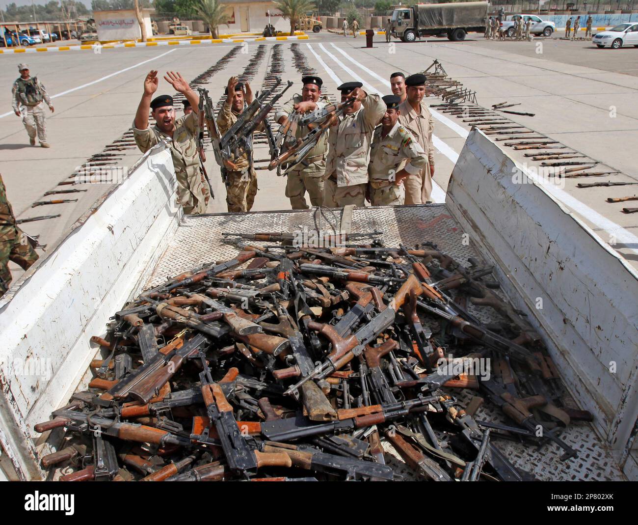 Iraqi Army soldiers load a truck carrying weapons seized by Iraqi ...