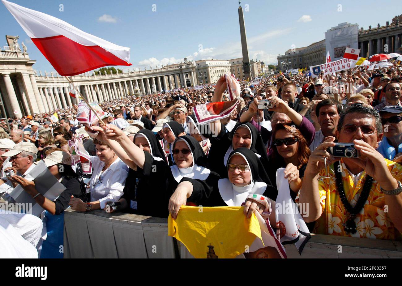 Polish nuns, at left waving national flags, photos and scarves, react ...