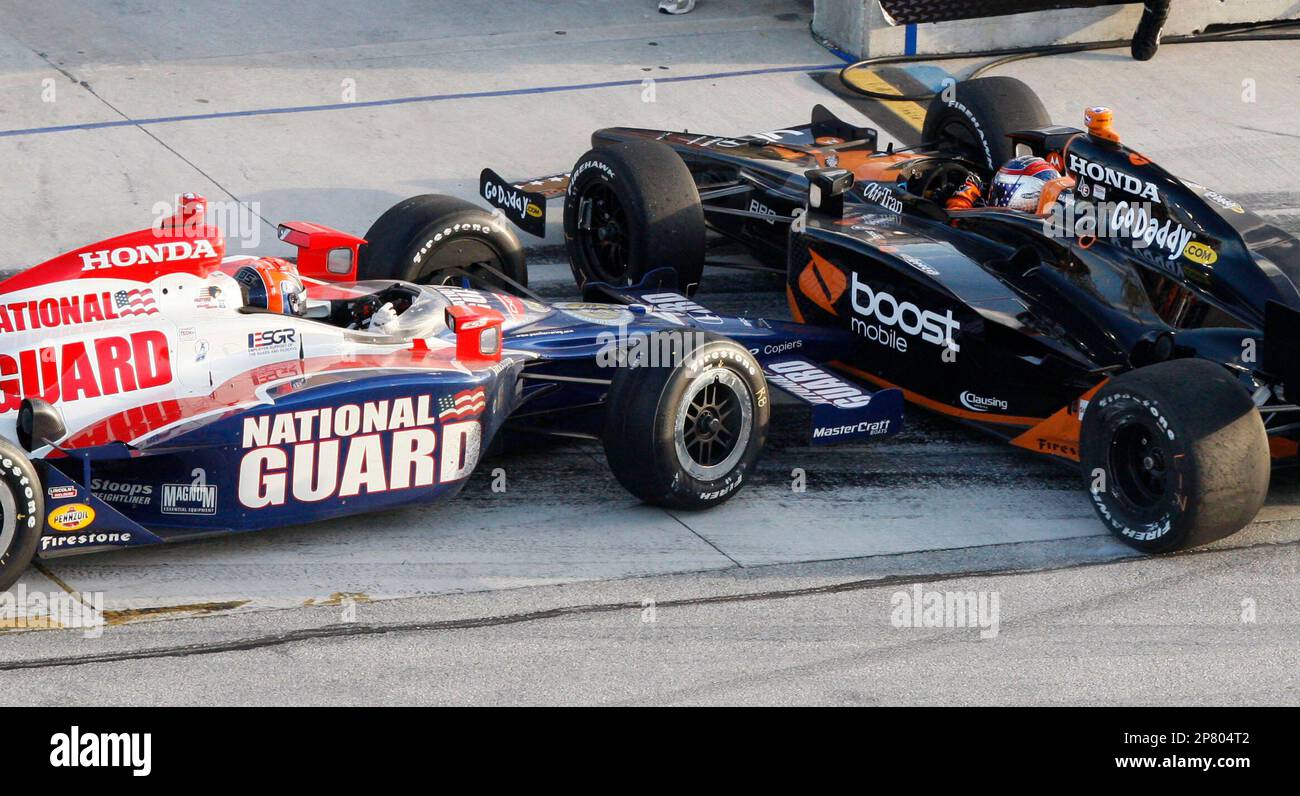 Dan Wheldon, of England, and Danica Patrick, right, collide in the pits ...