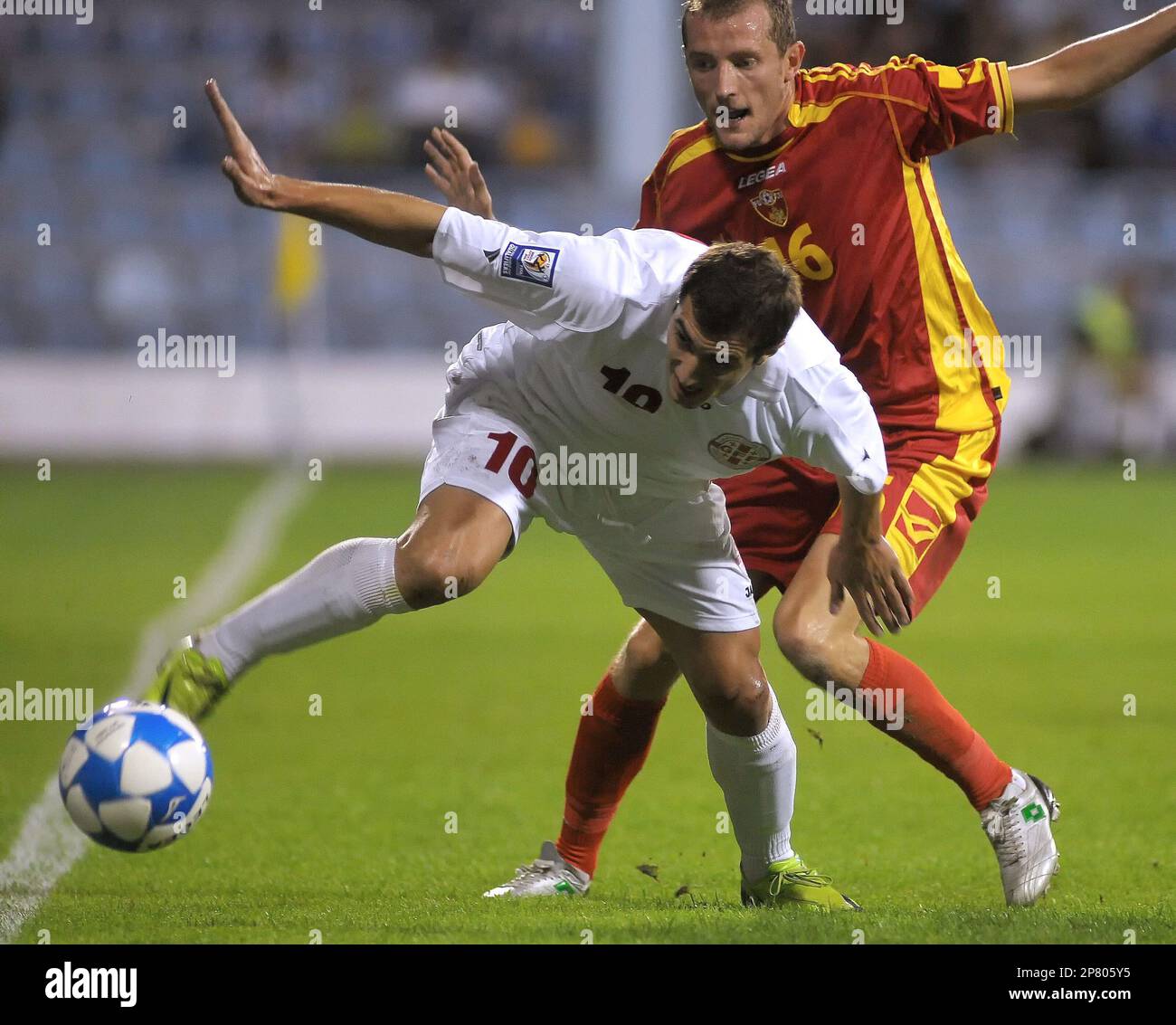 Merebashvili Giorgir, left, of Georgia is challenged for the ball by ...