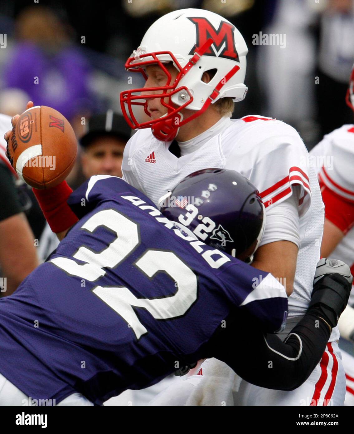 Northwestern's David Arnold (32) sacks Miami (Ohio) quarterback Zac ...