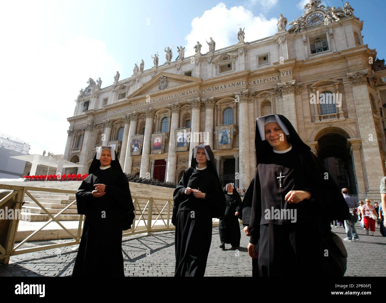 Nuns walk in front of St. Peter's Basilica at the Vatican a day before ...