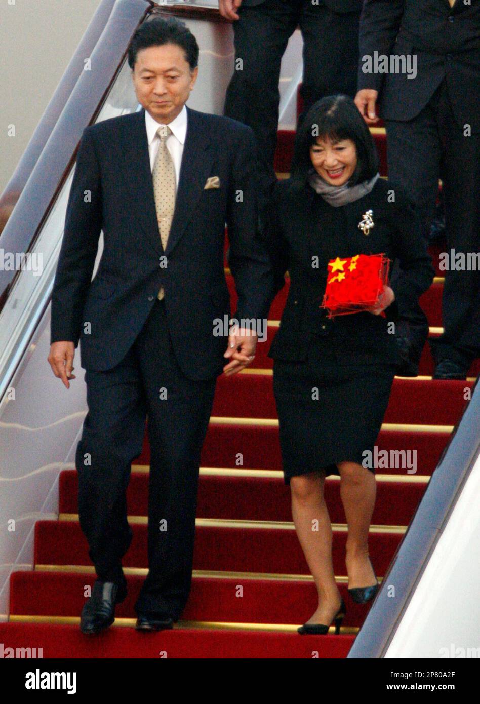 Japanese Prime Minister Yukio Hatoyama and his wife Miyuki, carrying a ...