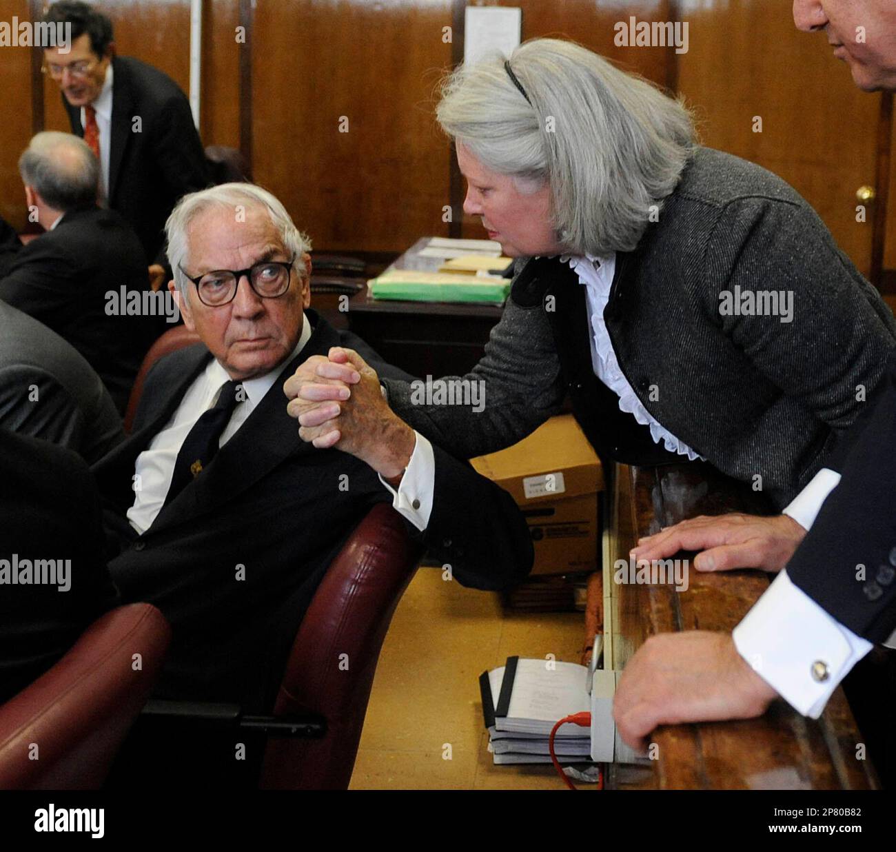 Anthony Marshall and his wife Charlene Marshall clasp hands in a ...