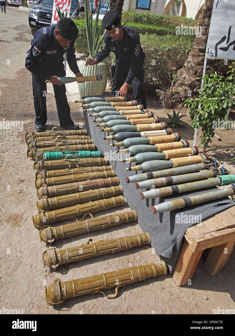 Iraqi national policemen check weapons and armaments seized by Iraqi ...