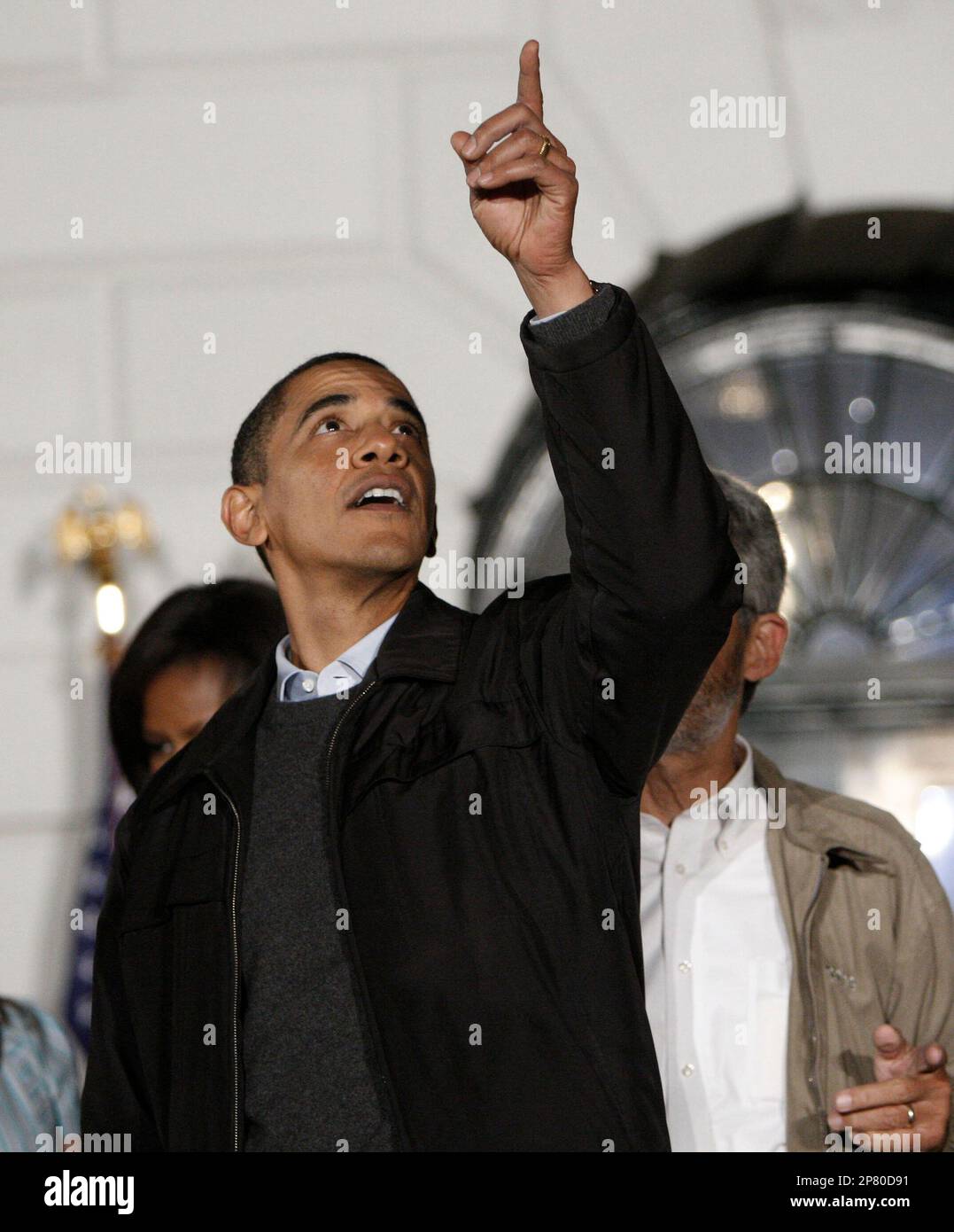 President Barack Obama points upwards after using a telescopes to star ...