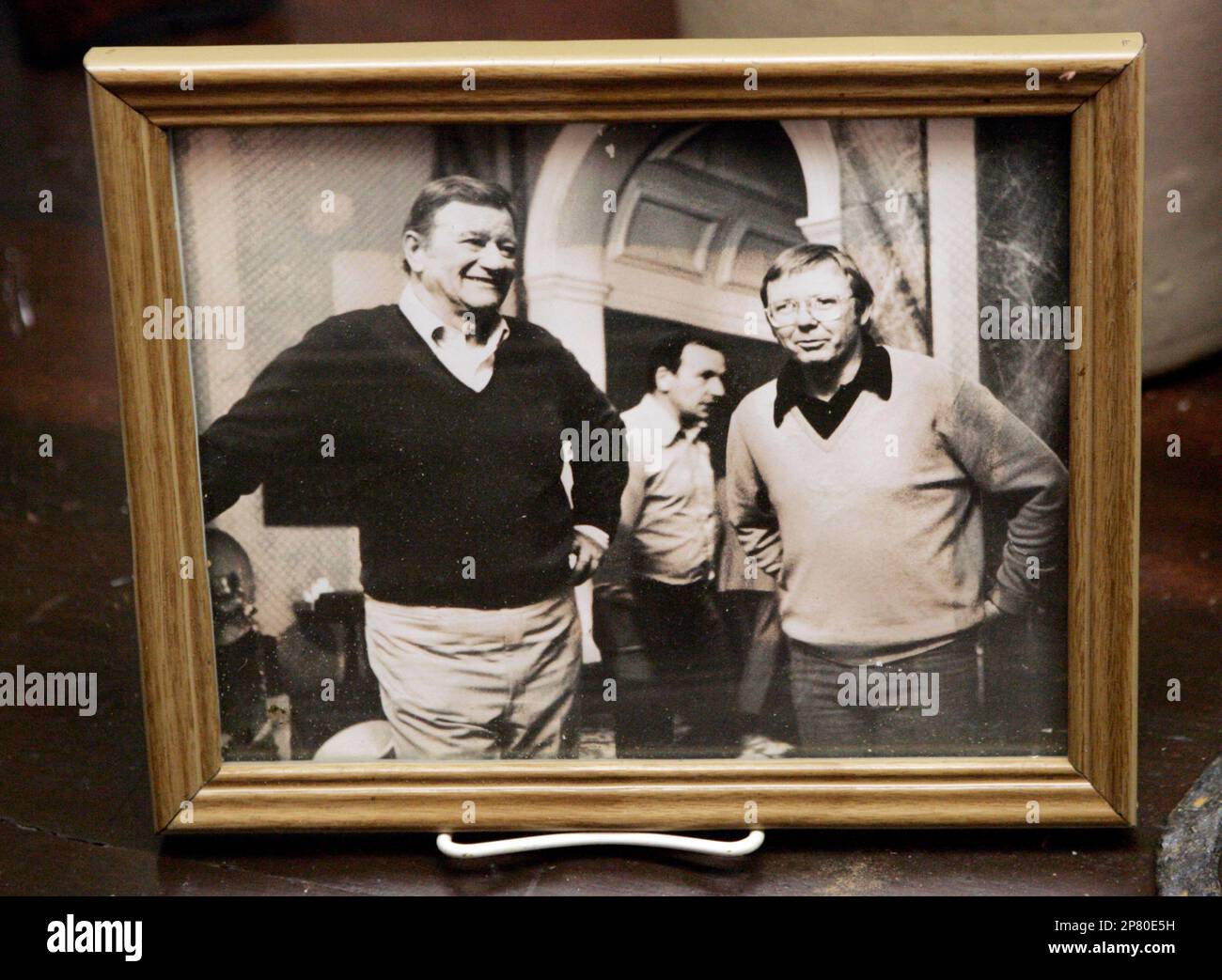 In this Sept. 24, 2009 photo, a photograph of John Wayne, left, and ...