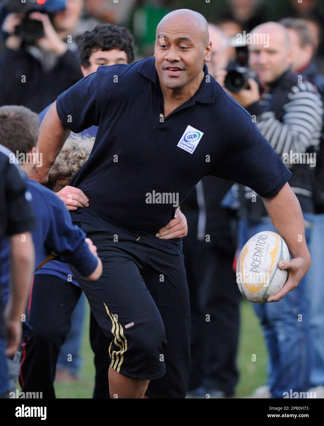 Former New Zealand rugby player Jonah Lomu plays a game with children ...