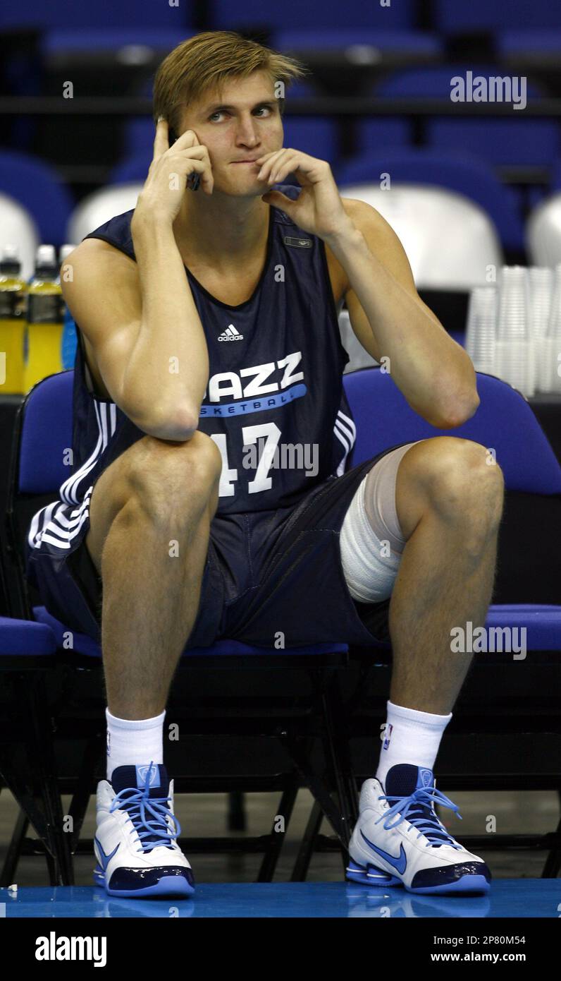 Utah Jazz's Andrei Kirilenko speaks on a phone during their practice session at the O2 Arena in ...
