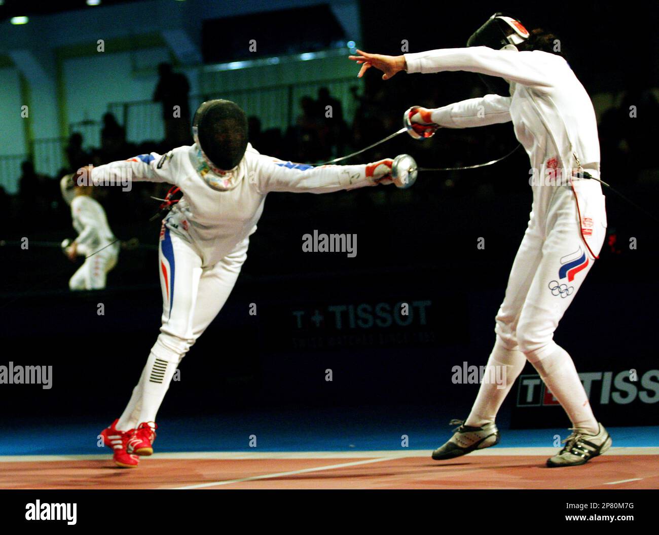 Laura Flessel-Colovic of France, left, and Lubov Shutova of Russia ...