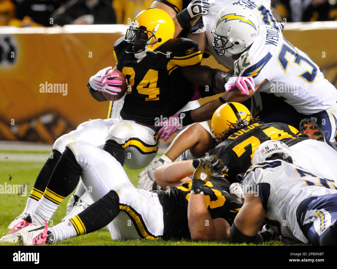 Pittsburgh Steelers running back Rashard Mendenhall, left, plows his ...