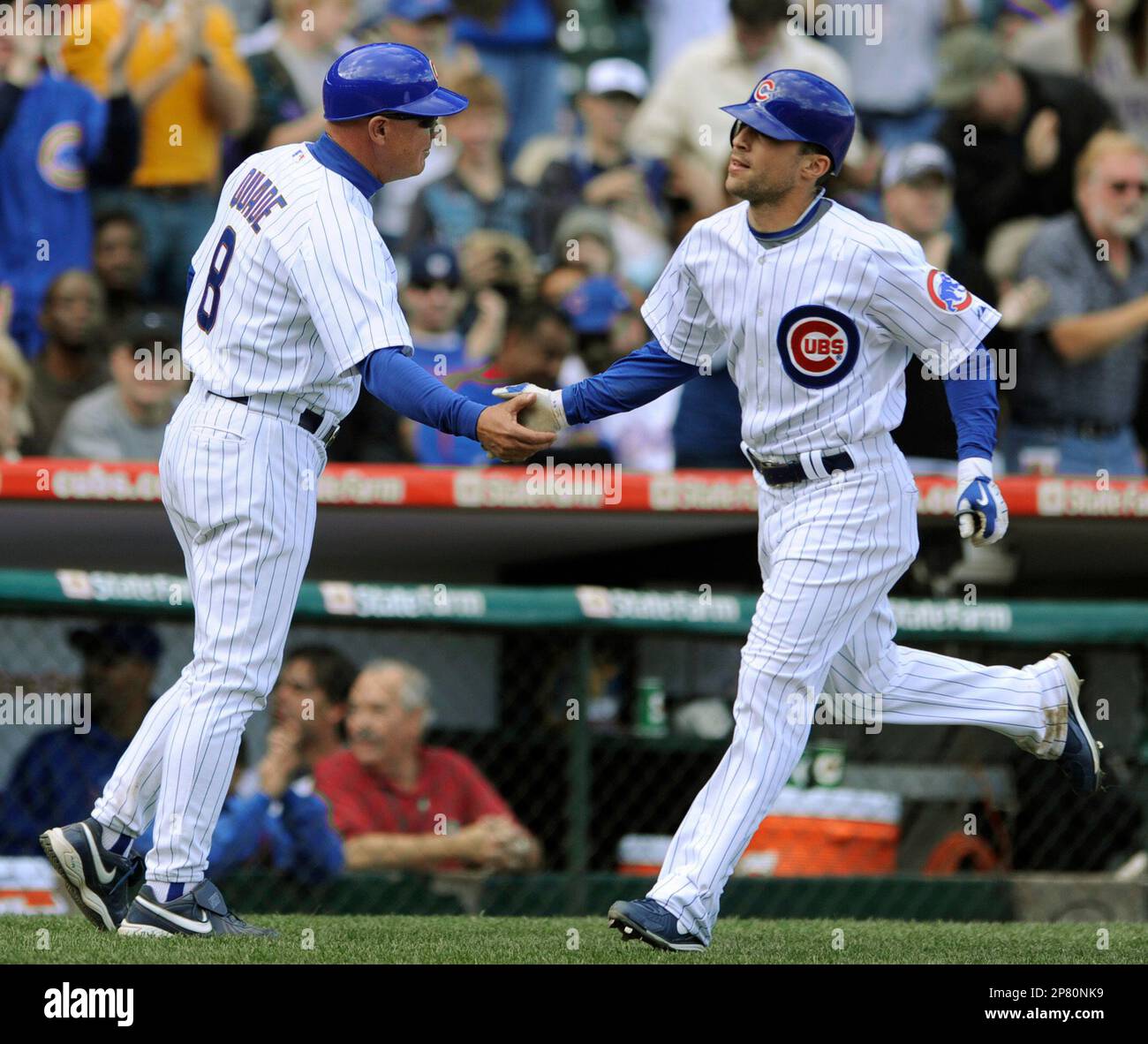 Chicago Cubs' Sam Fuld celebrates with third base coach Mike Quade ...