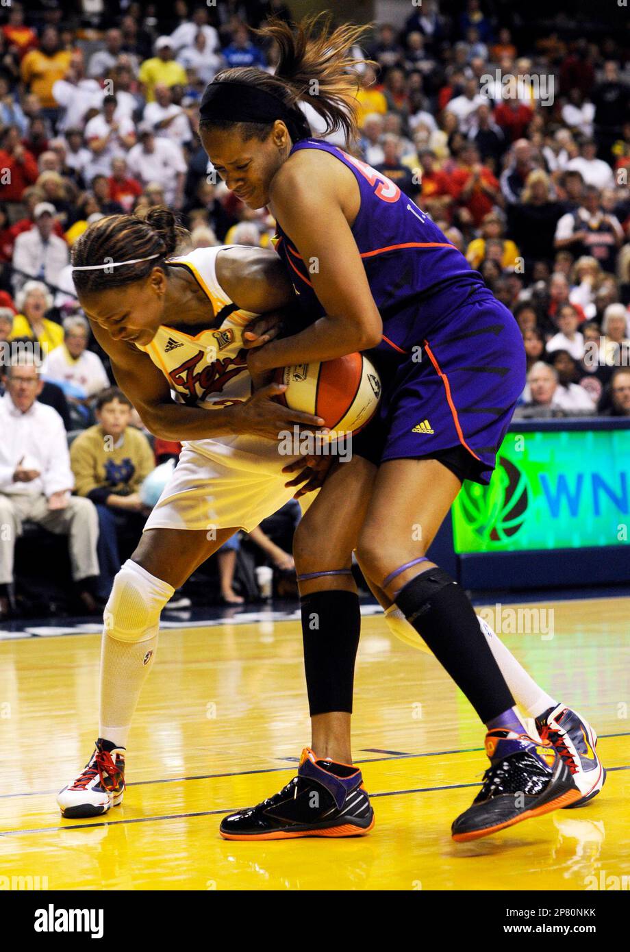 Indiana Fever forward Tamika Catchings, left, vies for possession of ...