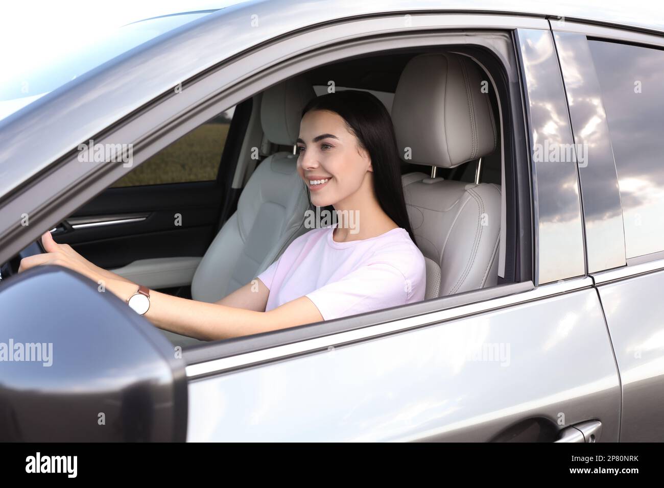 Beautiful young woman driving her modern car Stock Photo - Alamy