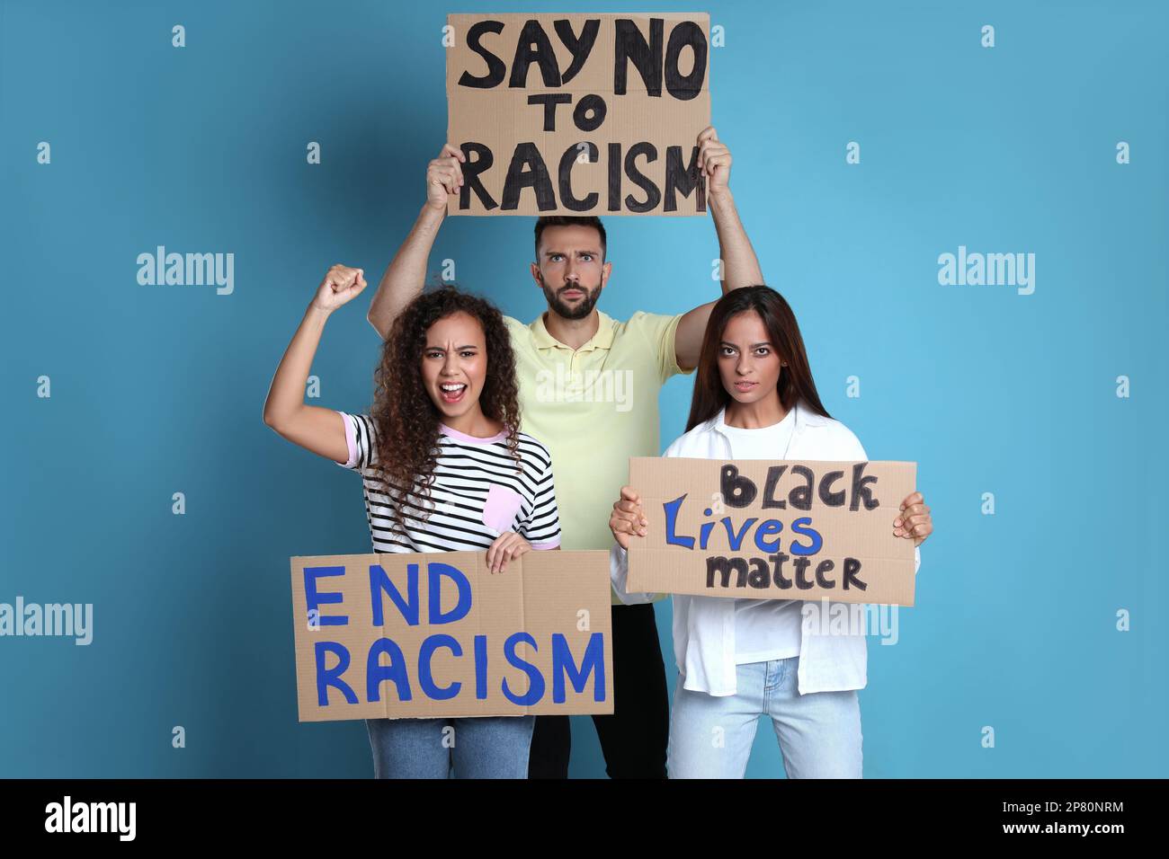 Protesters demonstrating different anti racism slogans on light blue ...