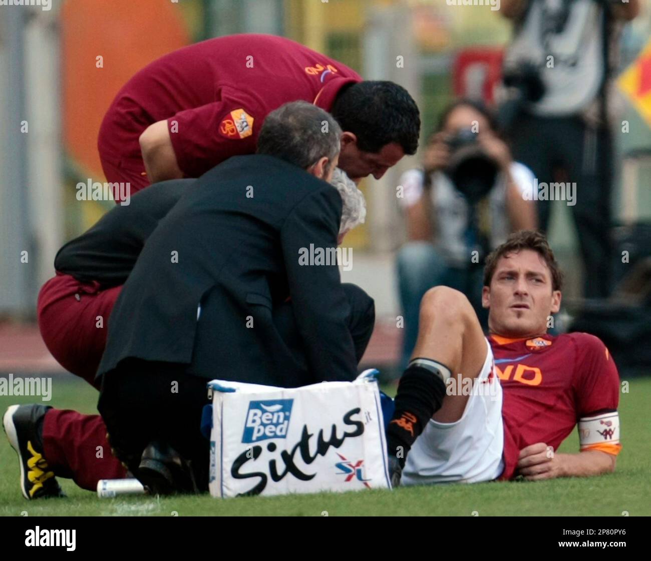 AS Roma's Francesco Totti, at right on the ground, reacts after a knee ...