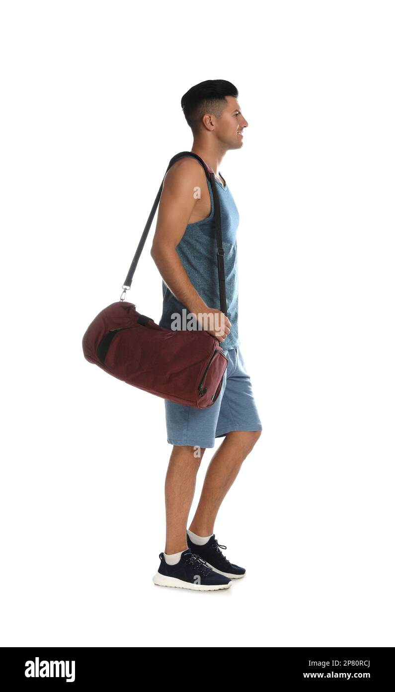 Handsome man with sports bag on white background Stock Photo - Alamy