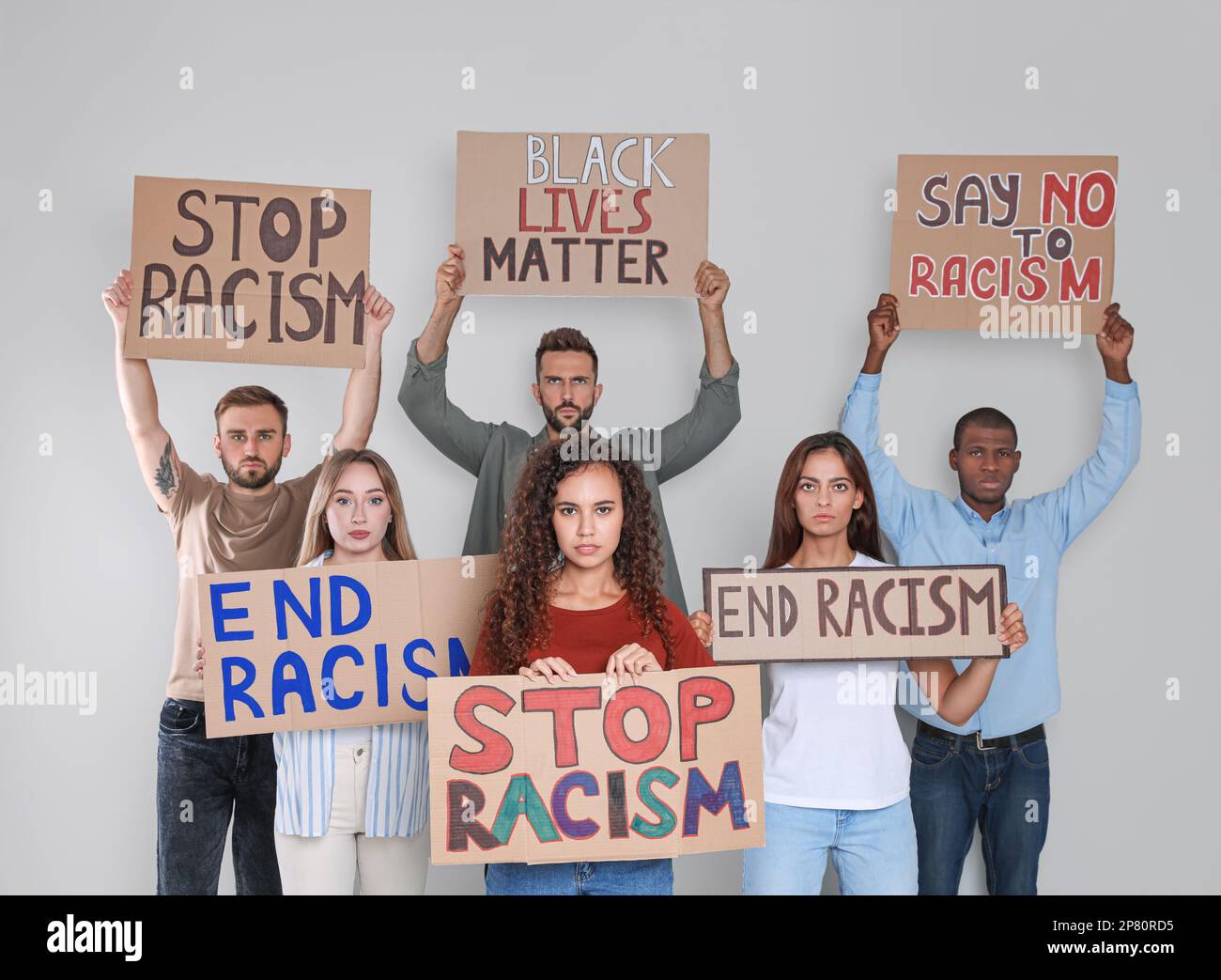 Protesters demonstrating different anti racism slogans on light ...