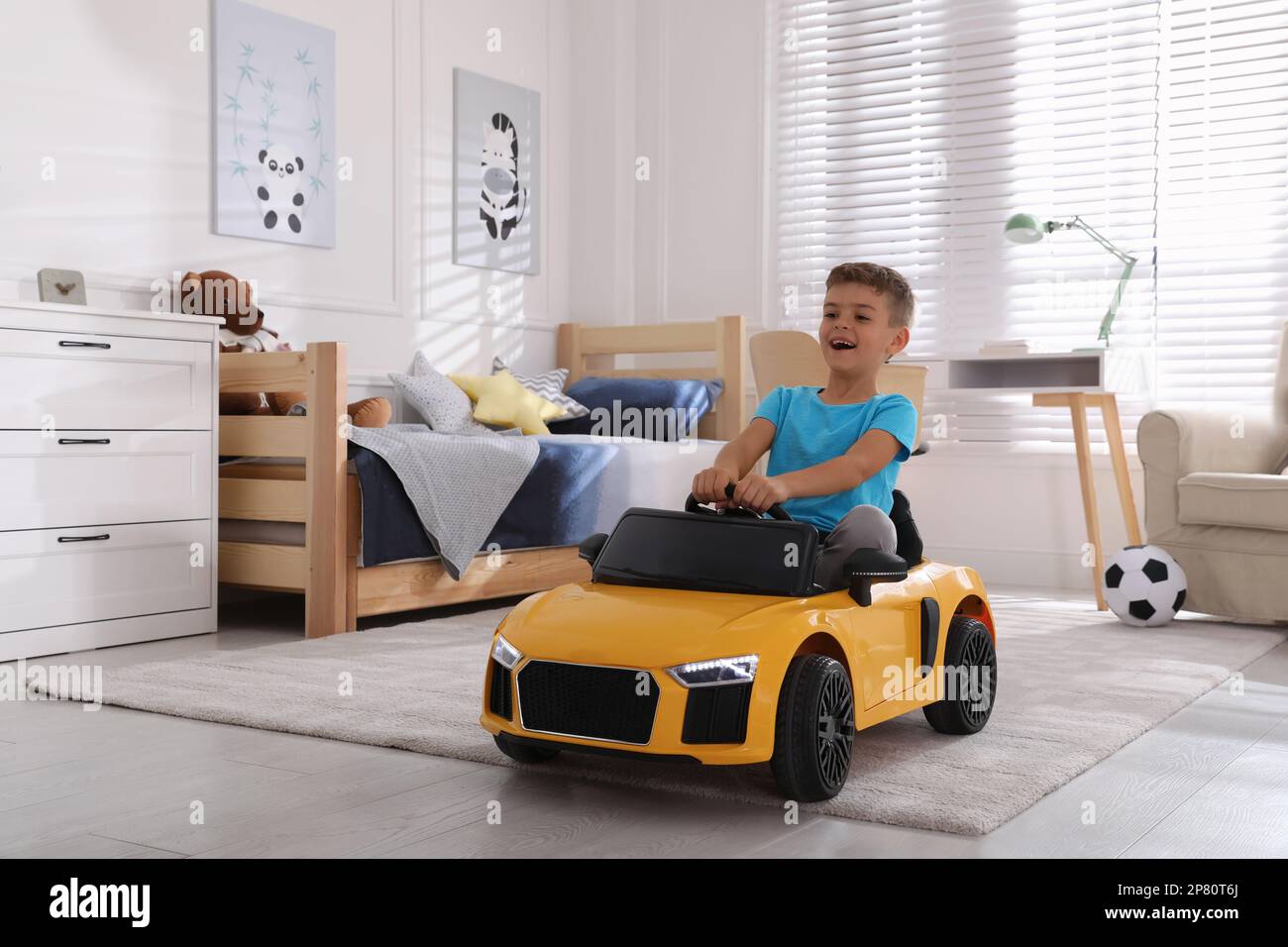 Cute little boy driving big toy car at home Stock Photo - Alamy