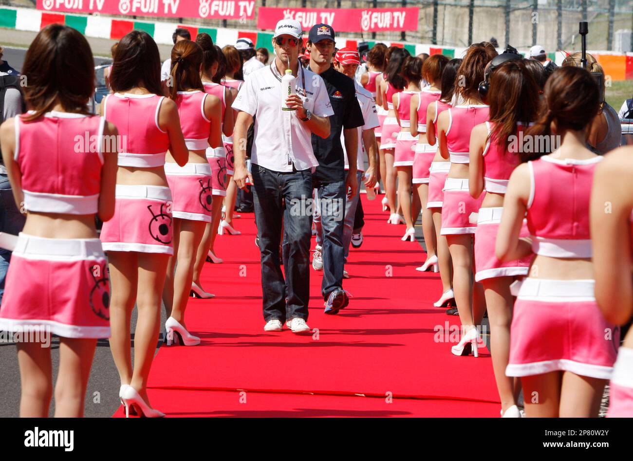 Britain's Brawn Formula One driver Jenson Button walks down a line of ...