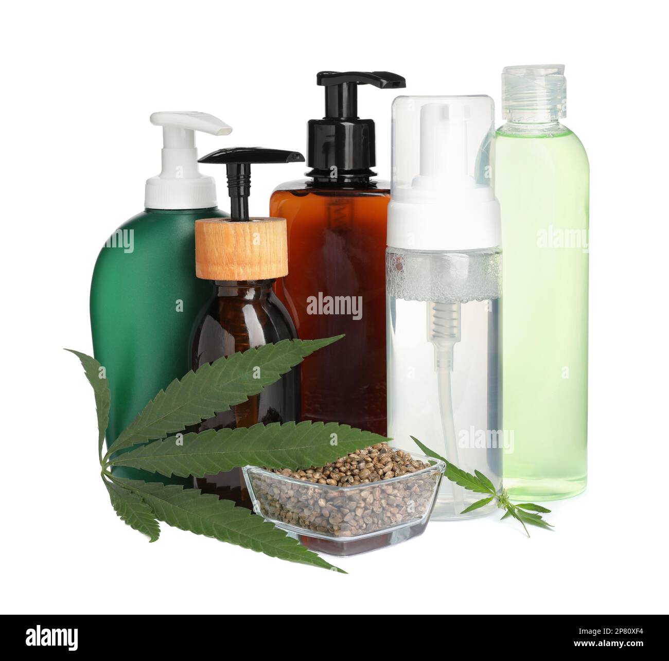 Set of hemp cosmetics with green leaves and seeds isolated on white ...