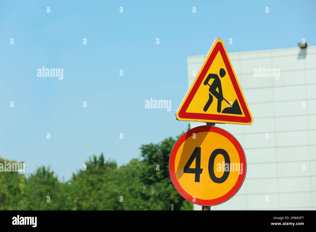 Road construction and speed limit signs outdoors on sunny day. Repair ...