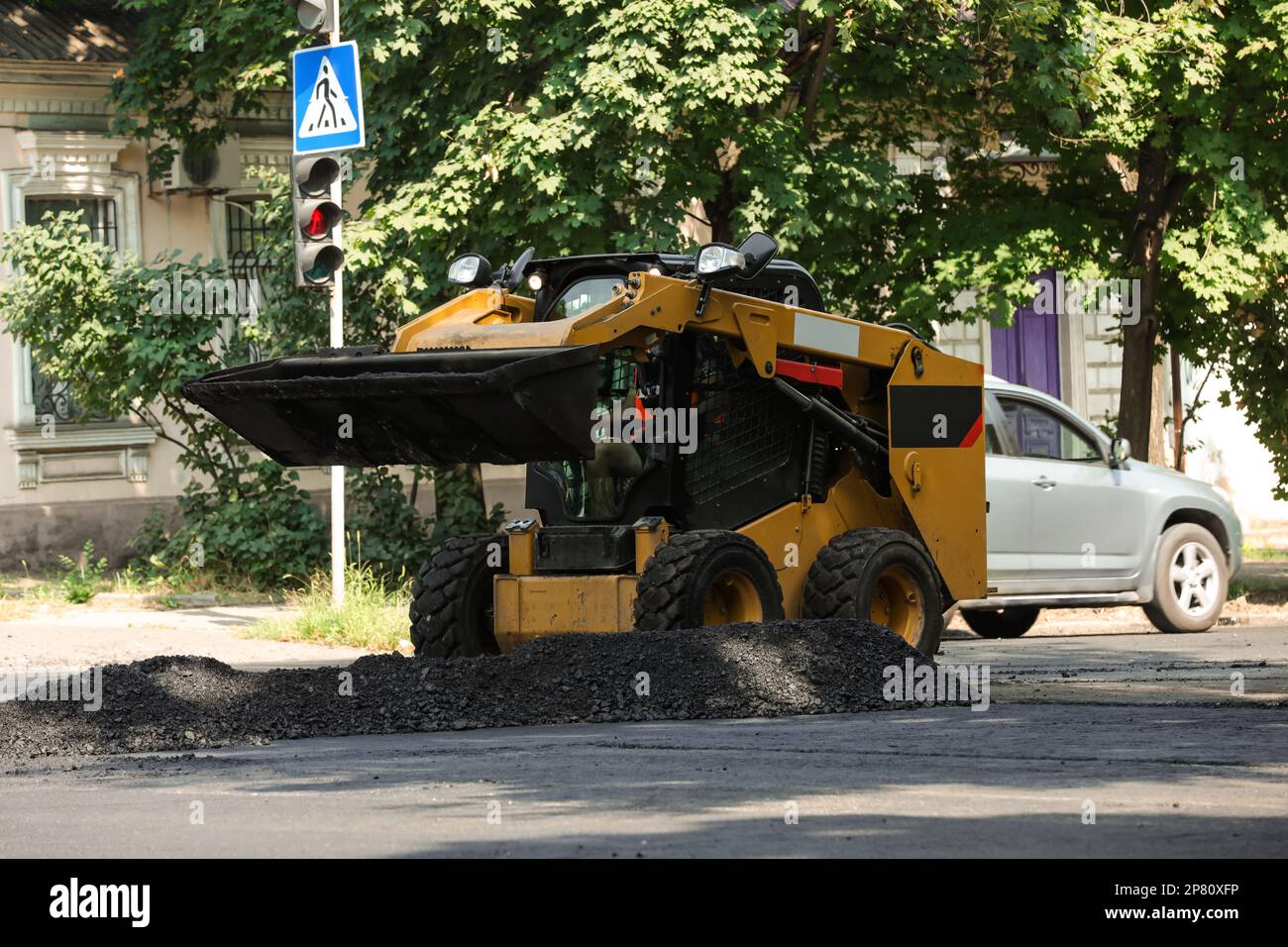 Modern skid loader on city street. Road repair service Stock Photo - Alamy