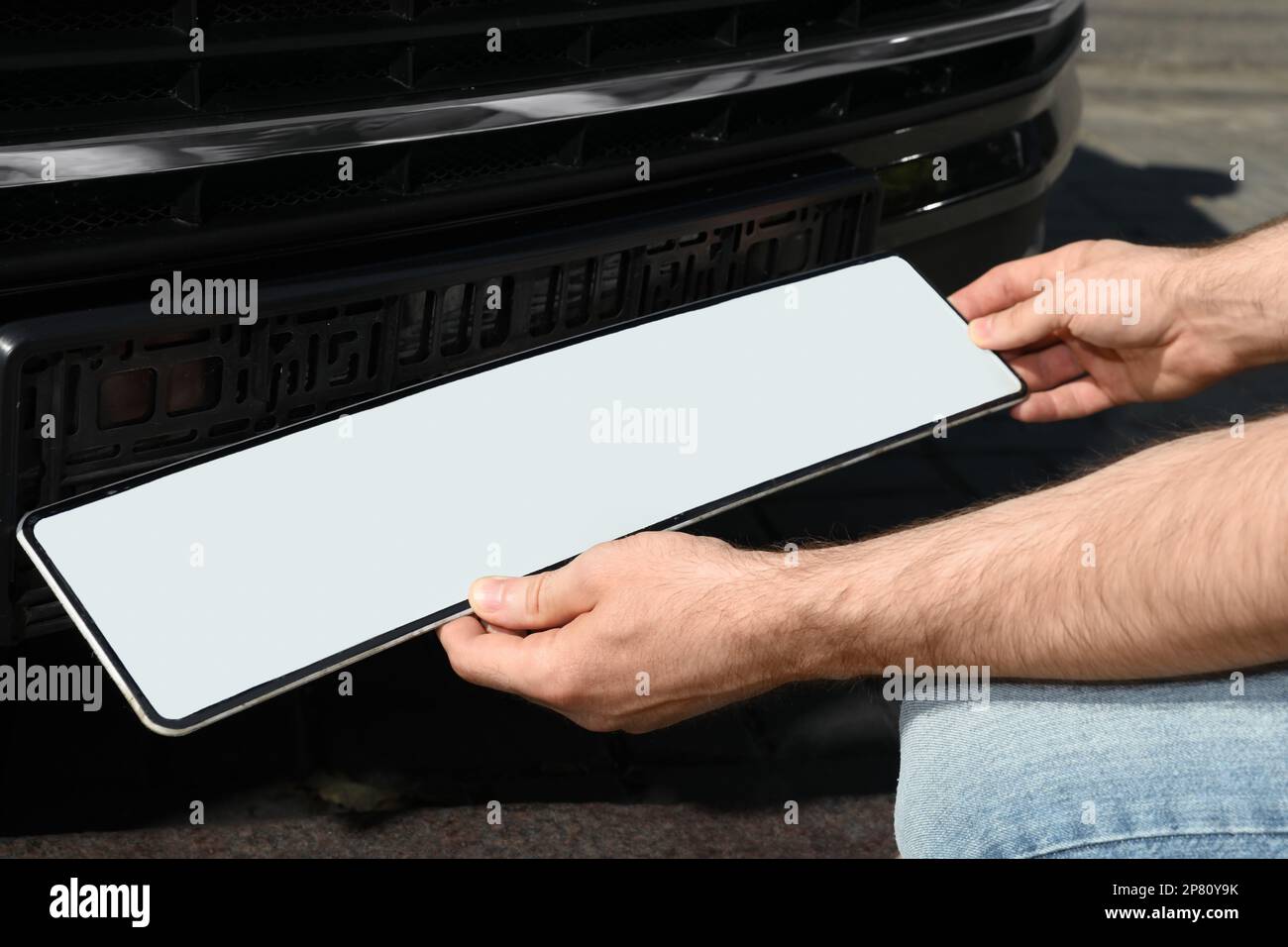 Man installing vehicle registration plate outdoors, closeup Stock Photo ...