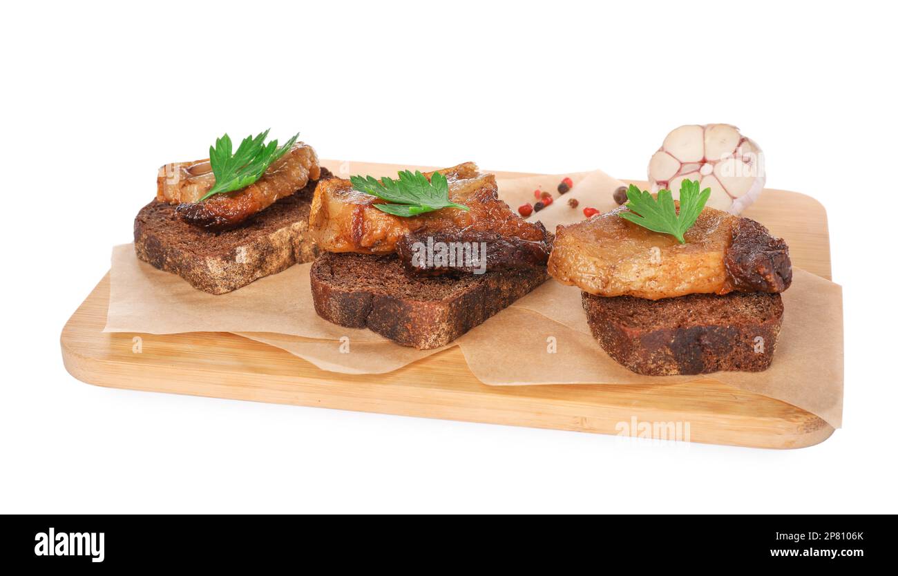 Rye bread with tasty fried cracklings and parsley on white background ...