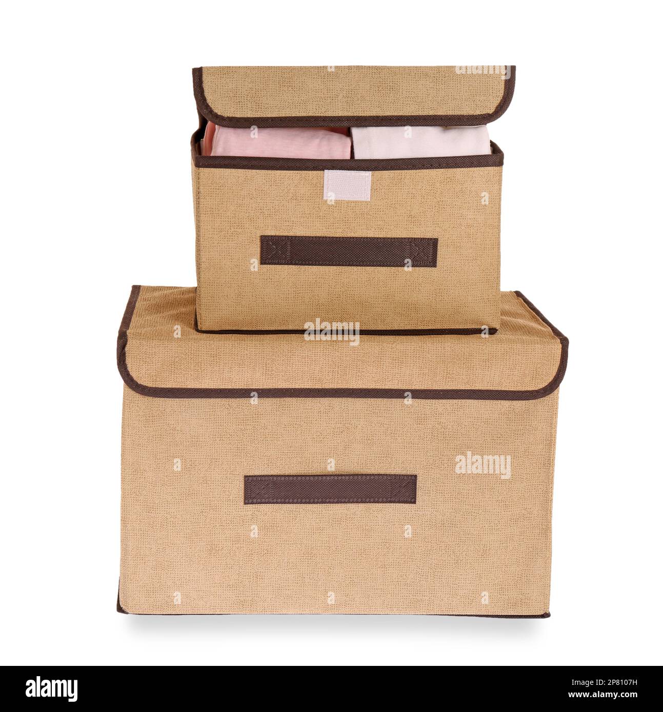 Textile storage cases with folded clothes on white background Stock ...