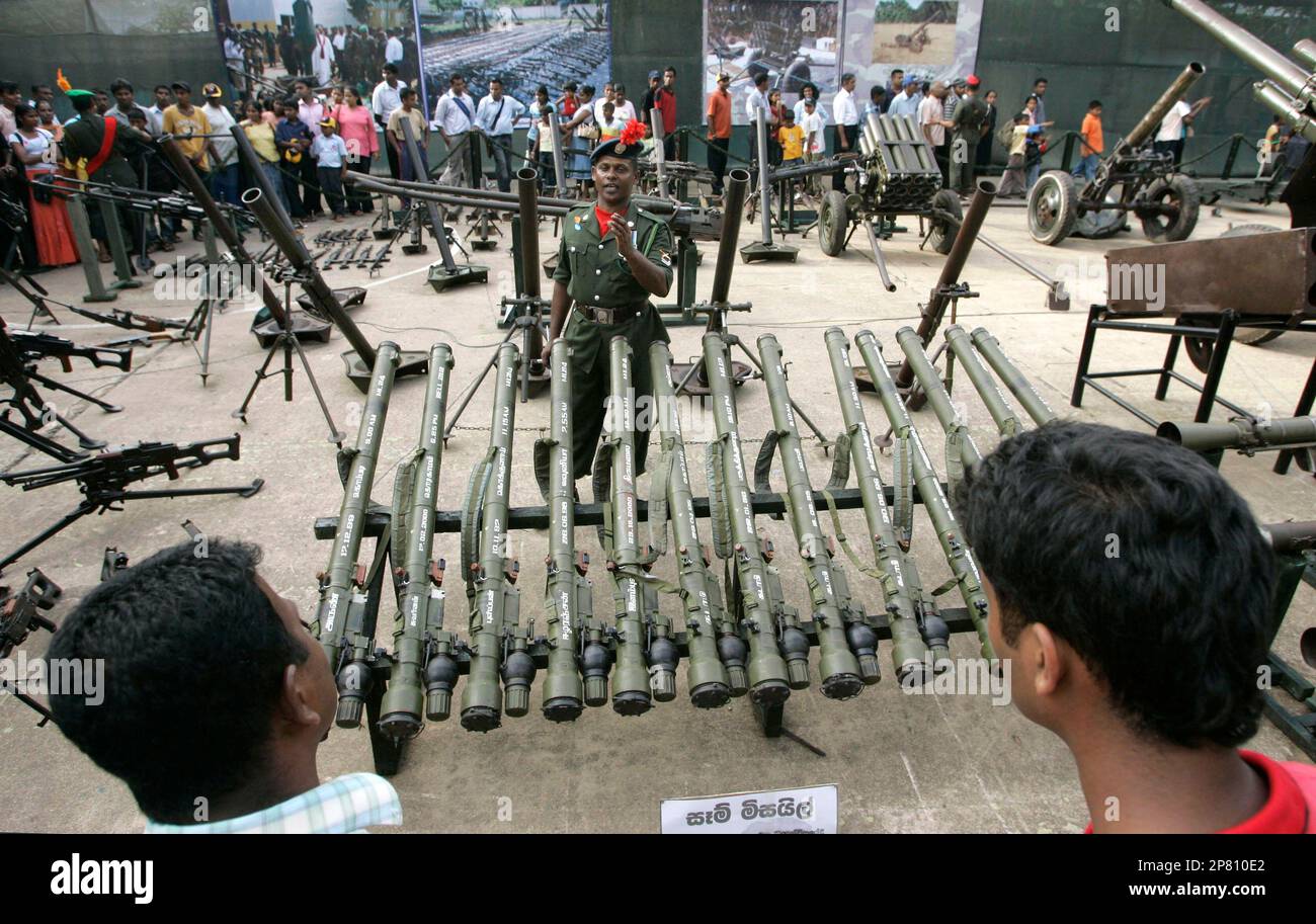 A Sri Lankan soldier briefs visitors about weapons used by the Tamil ...