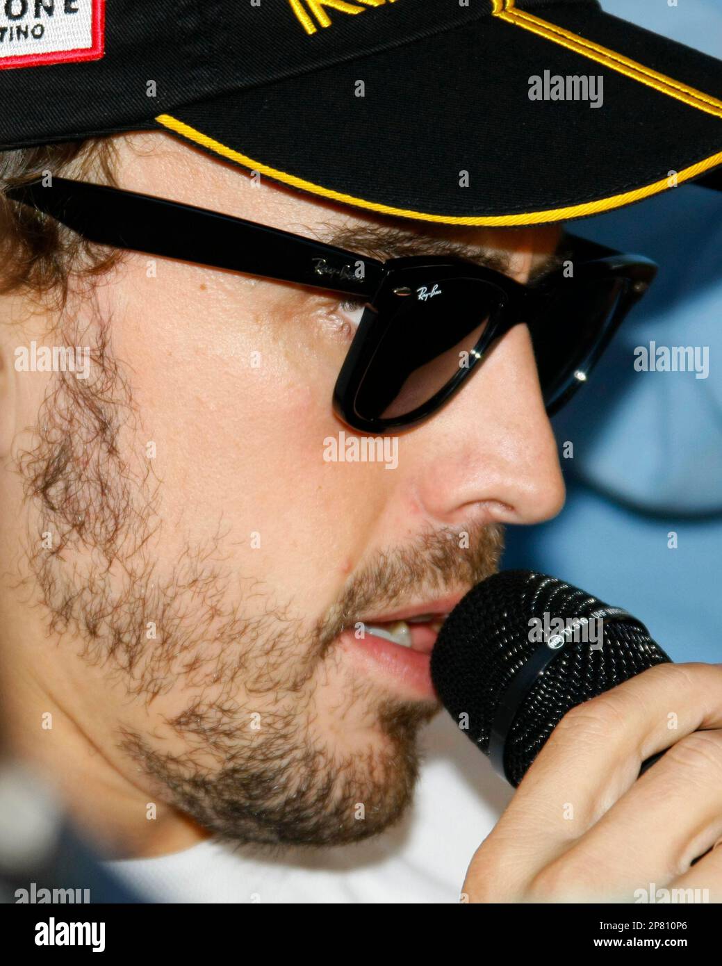 Renault Formula One driver Fernando Alonso of Spain speaks outside his ...