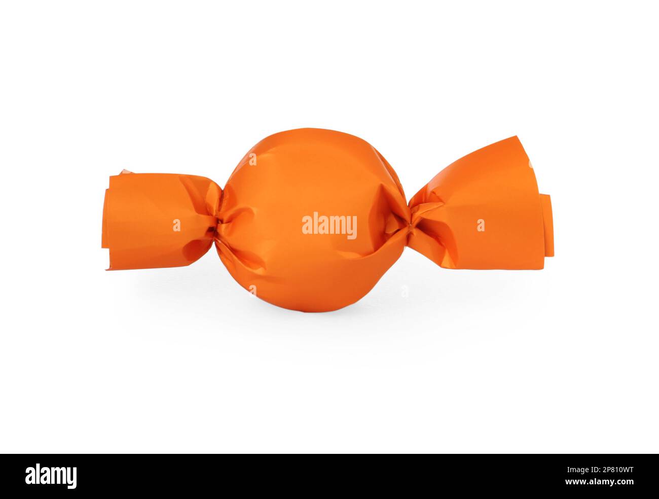 Delicious candy in orange wrapper isolated on white Stock Photo - Alamy