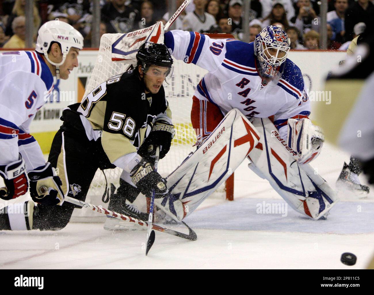 Pittsburgh Penguins' Kris Letang (58) battles for position between New ...