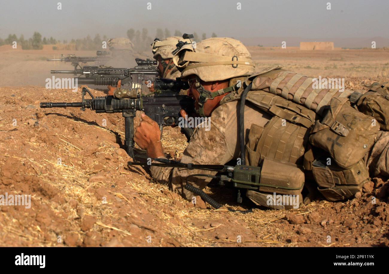 U.S. Marines fire at Taliban positions, during a firefight in Nawa ...
