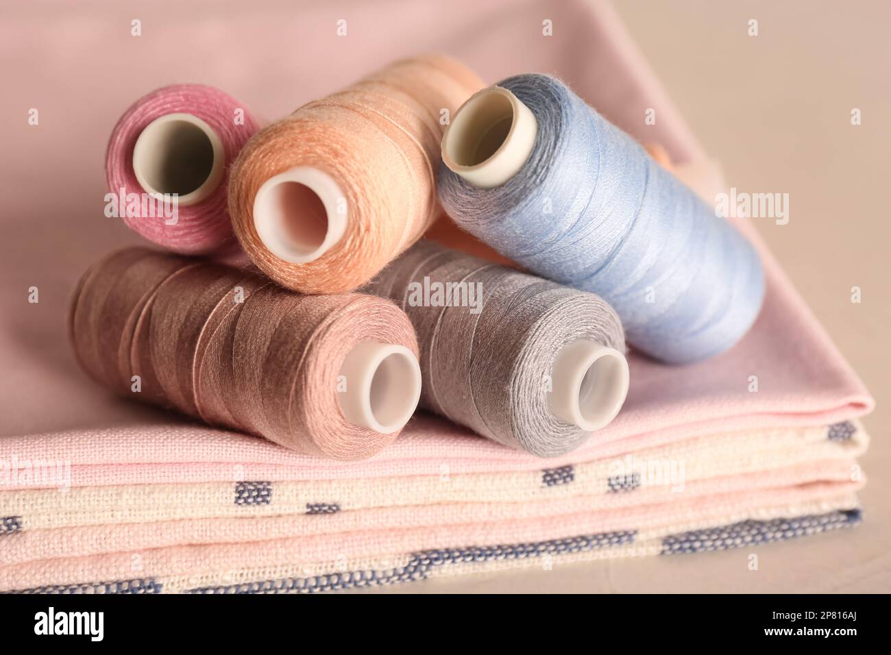 Set of color sewing threads on light grey table, closeup Stock Photo ...