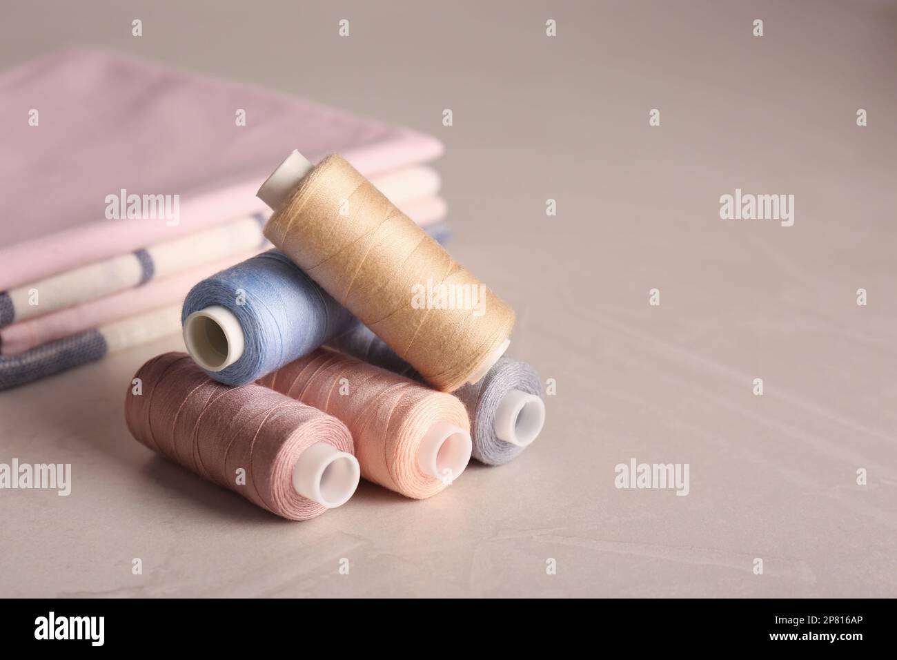 Set of color sewing threads on light grey table, space for text Stock ...