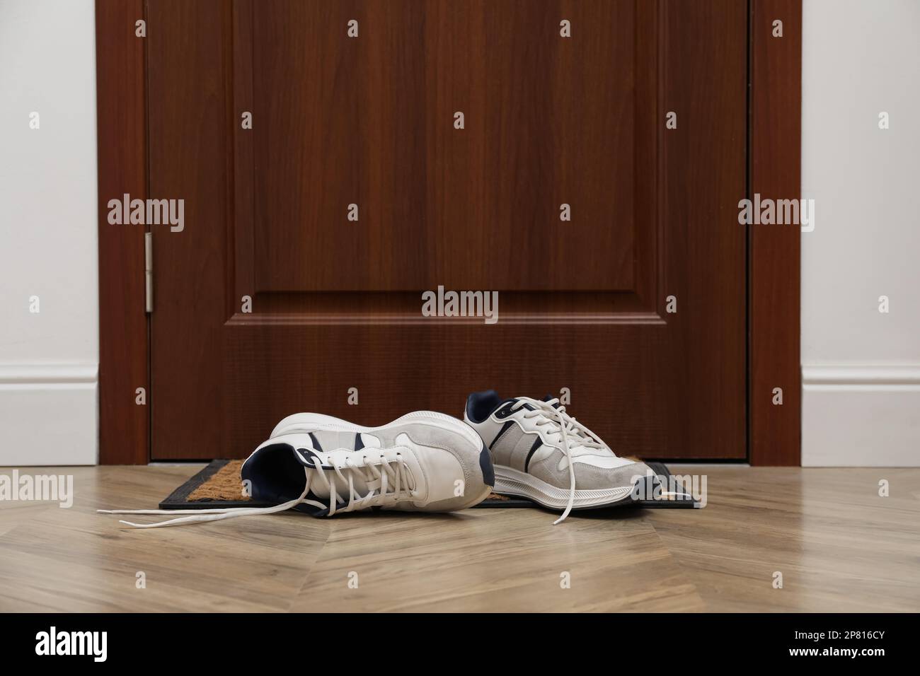 Shoes on door mat hi-res stock photography and images - Alamy