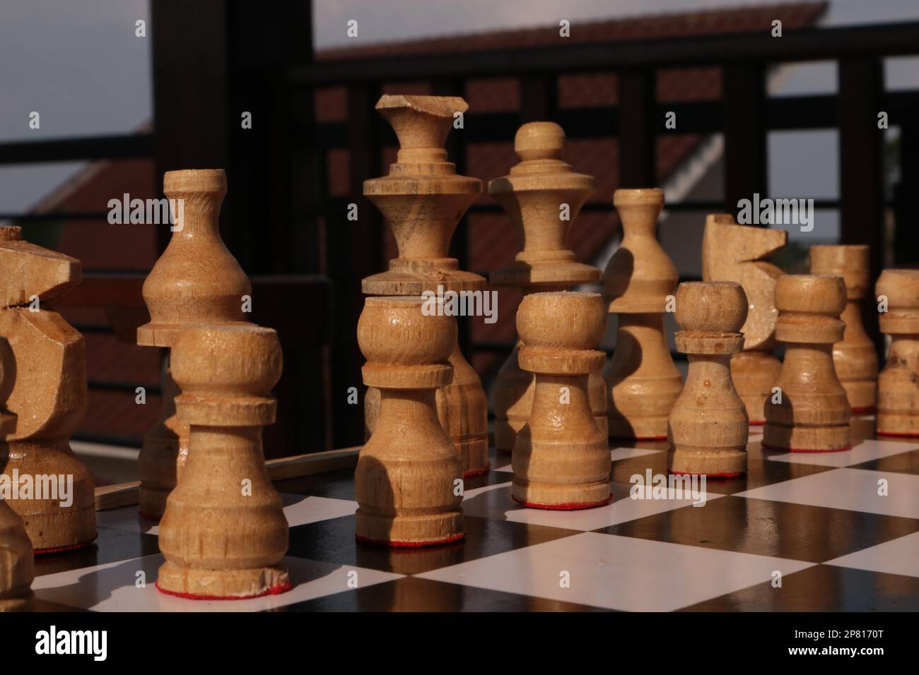 wood chess pieces on board game. great for background. with space for ...