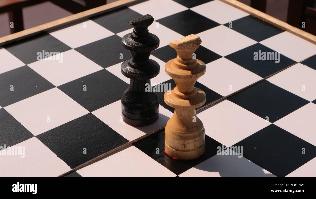wood chess pieces on board game. great for background. with space for ...