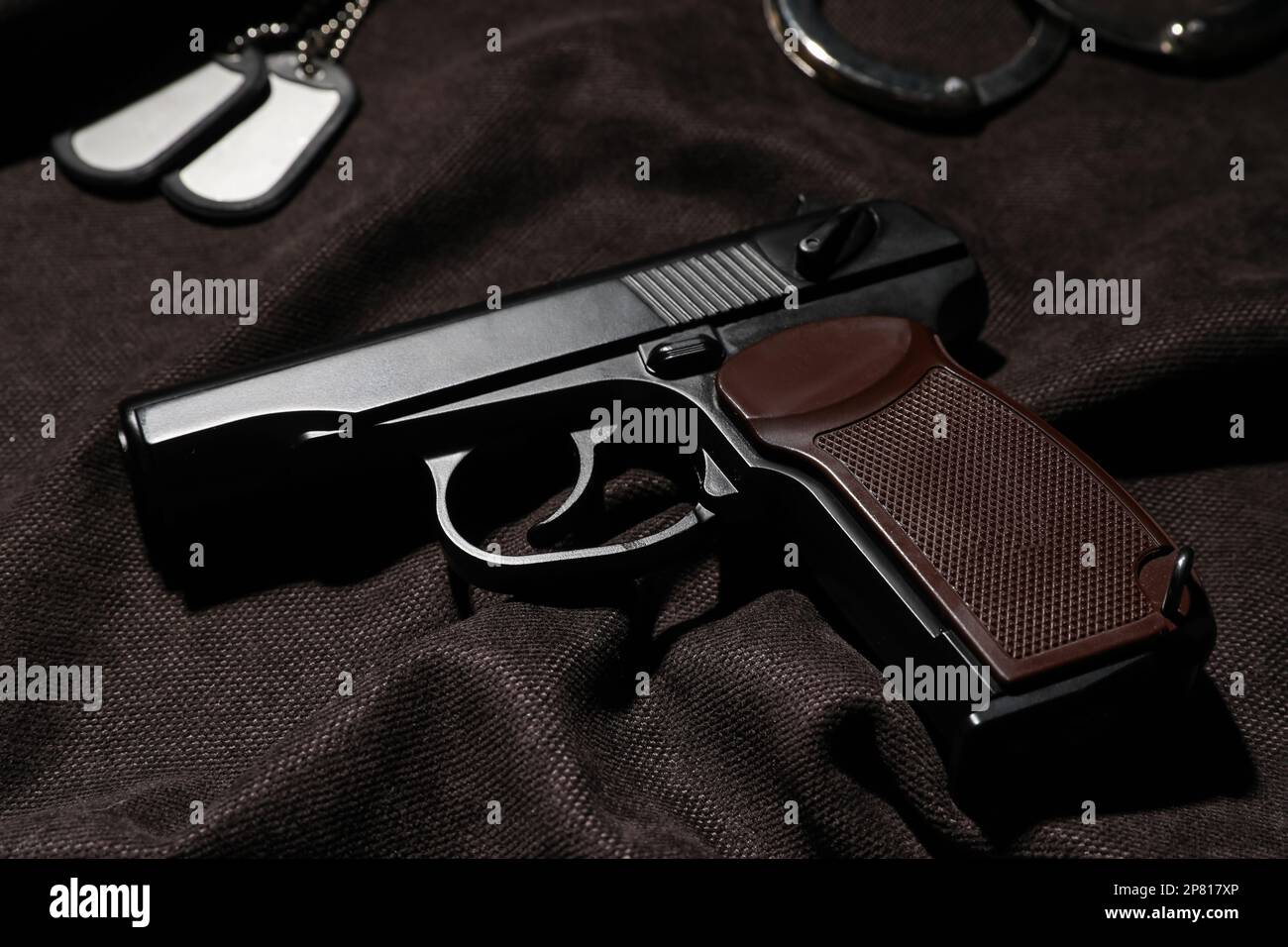 Standard handgun on dark fabric. Semi-automatic pistol Stock Photo - Alamy
