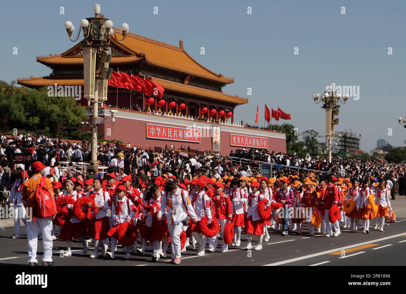 Chinese students walk in front of Tiananmengate after a military parade ...