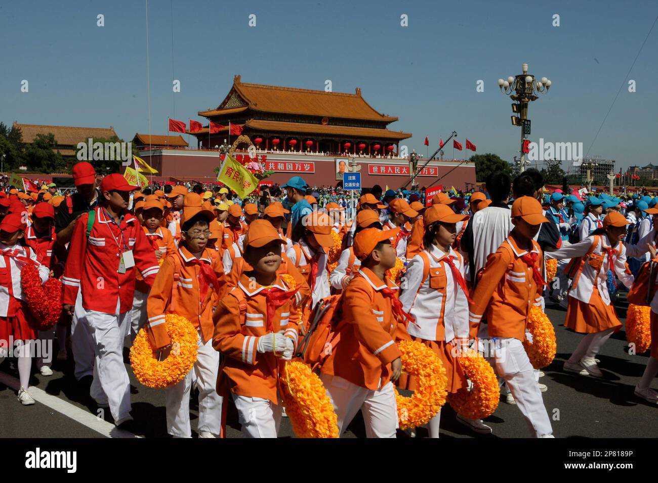 Chinese students walk in front of Tiananmen Gate after a military ...